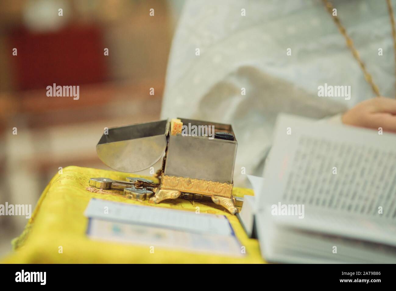 Open Gospel and large cross on throne of Orthodox church in baptism ...