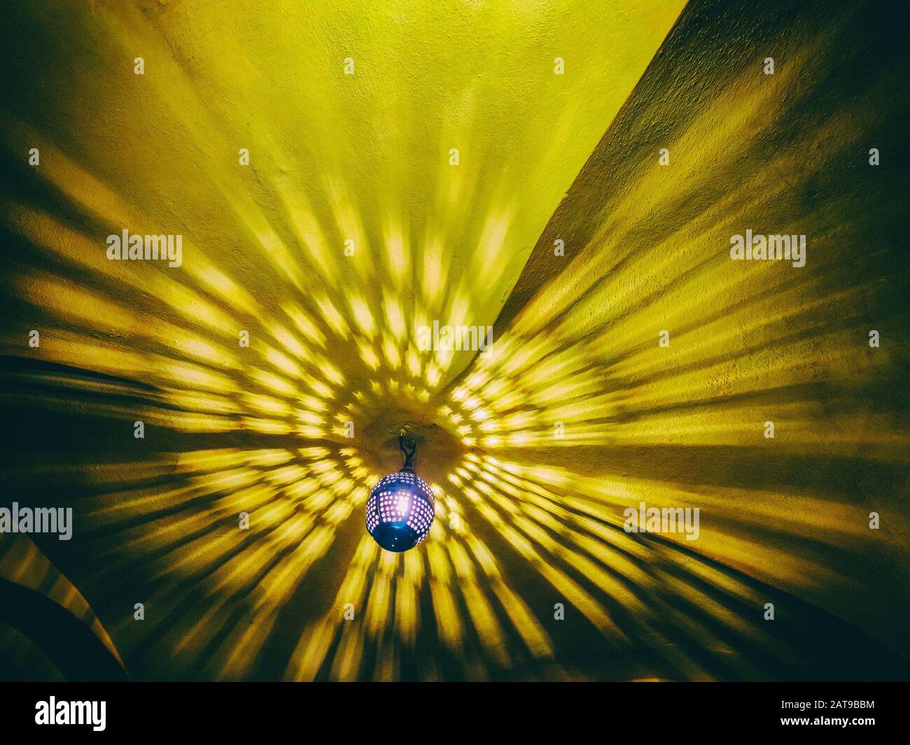 An old chandelier on the ceiling makes beautiful shadows and light ...