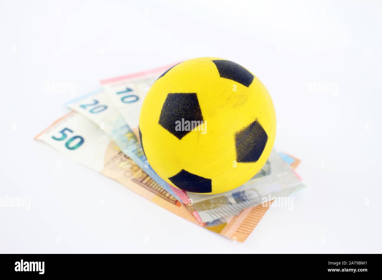 Soccer ball over euro money Stock Photo - Alamy