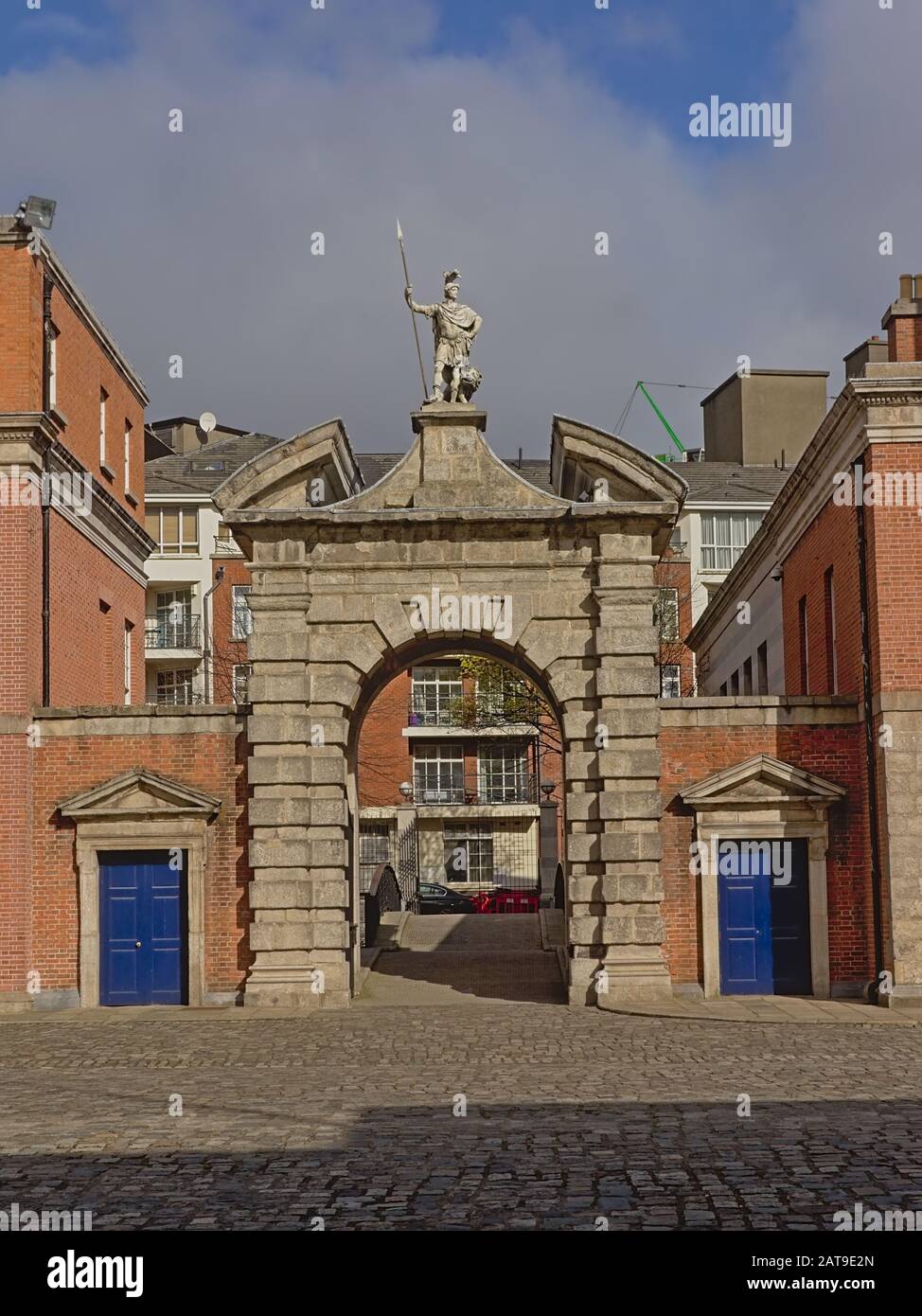 Arch Gate to Dublin castle with statue of fortitude on a sunny day ...