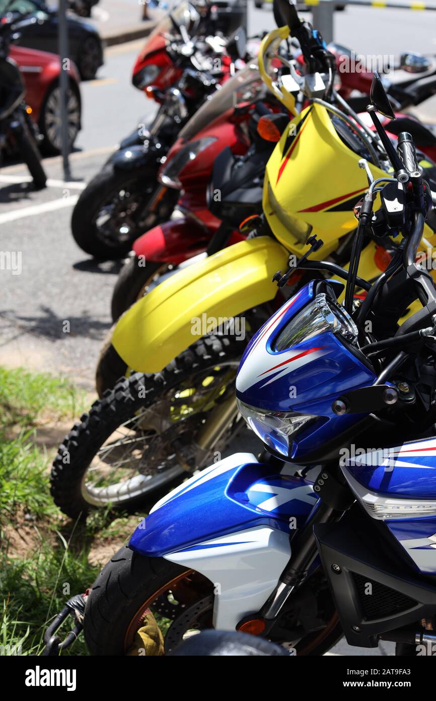 Motorcycle: Brightly colored bikes in a row, parked outside in the city ...