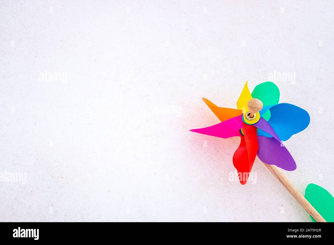 Colorful pinwheel on snow, isolated white background Stock Photo - Alamy