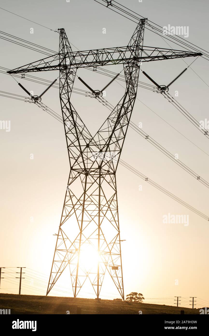 landscape of Australian high voltage power lines with sunset behind ...