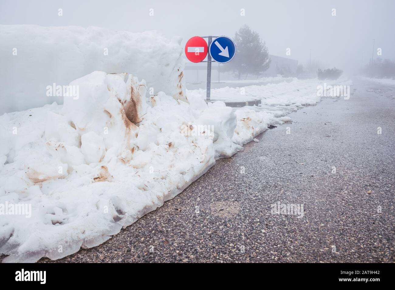 Road signs in the fog during a snow blizzard Stock Photo - Alamy