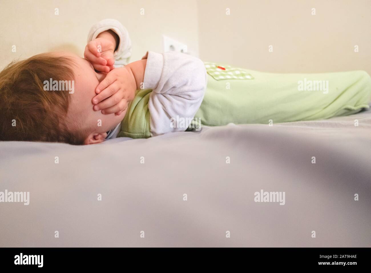 Baby sleeps on a bed in a poor marginal family Stock Photo - Alamy