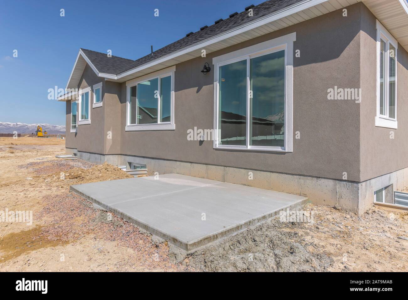 Construction outside a home with flat concrete surface surrounded by ...