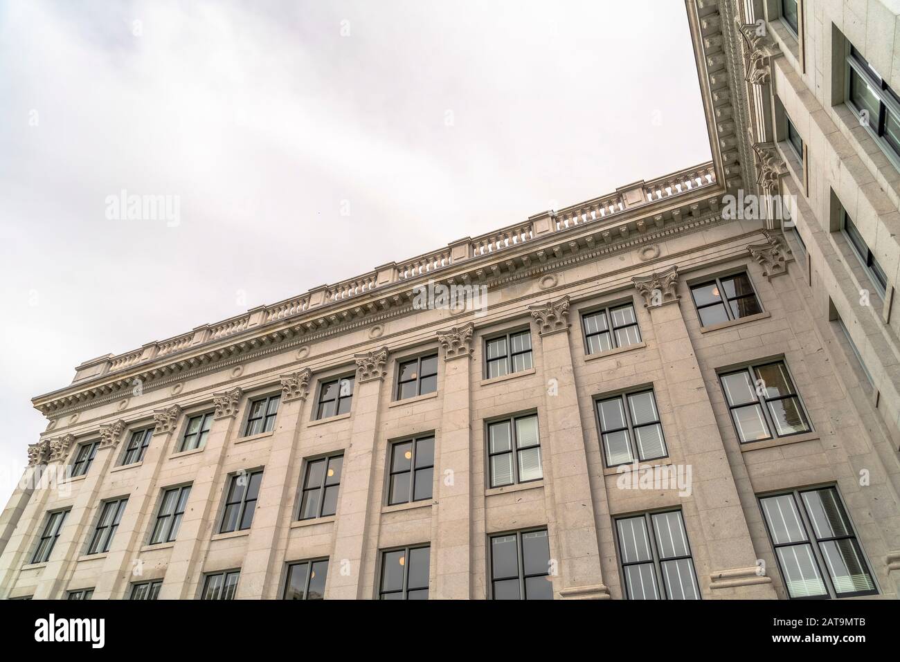 Building with decorative wall mouldings and shiny windows against ...