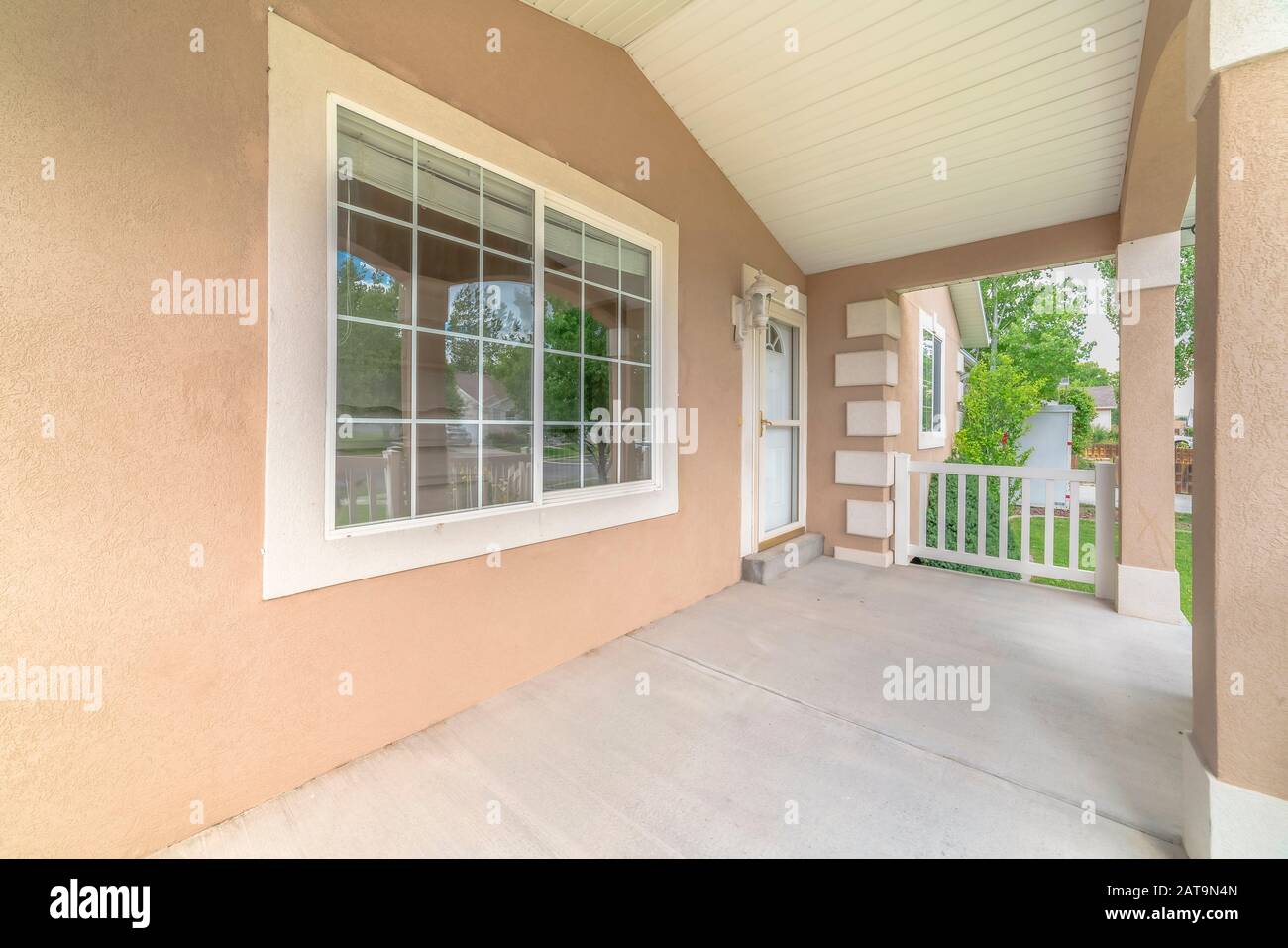 Home exterior with view of the large window and front door at the porch ...