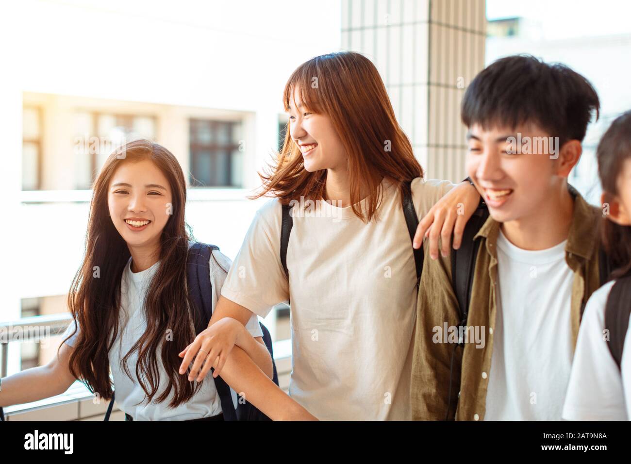 Group of happy students walking along the corridor at college Stock ...