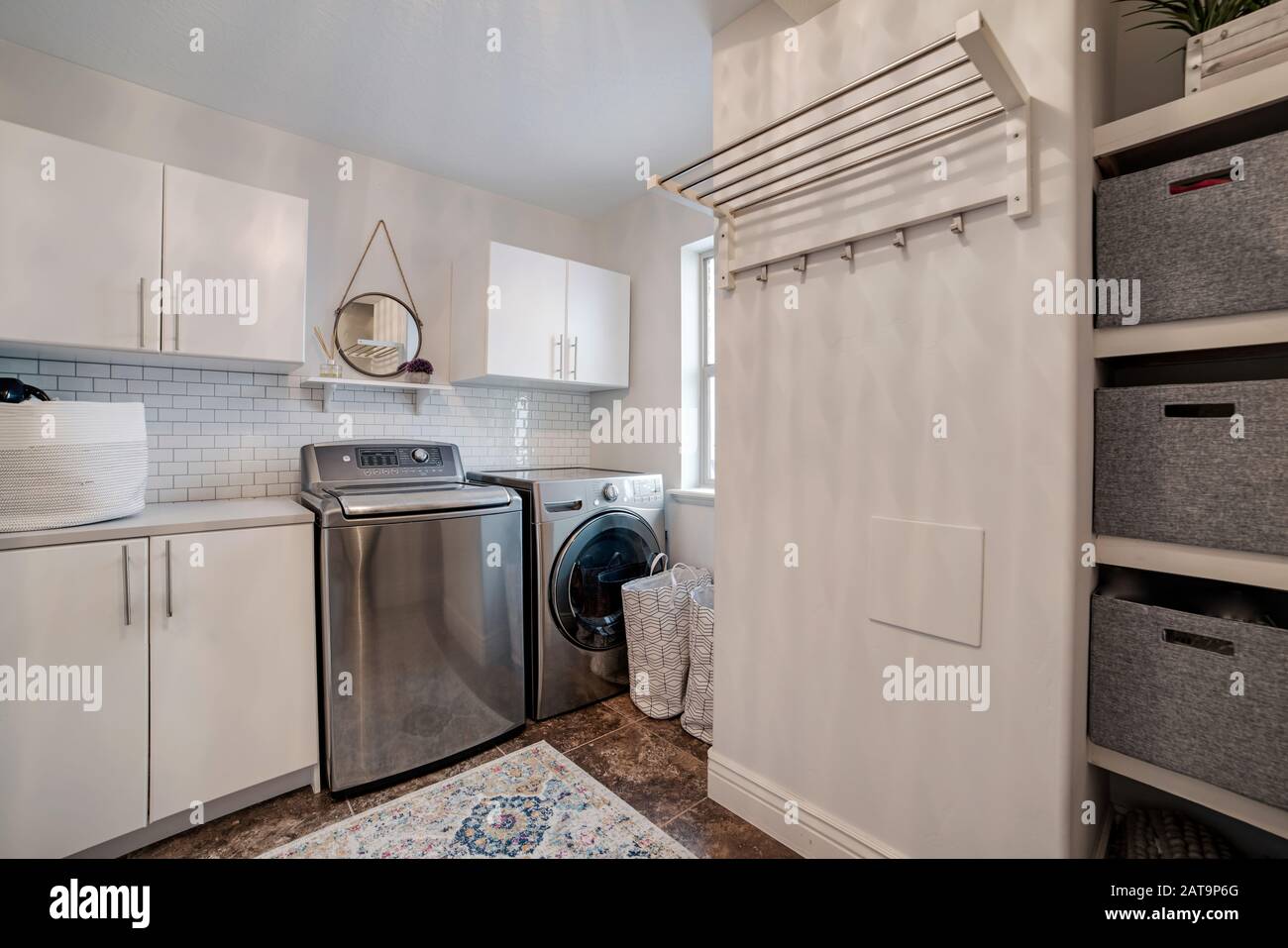 Laundry room interior with cabinets wahing machine and dryer against ...