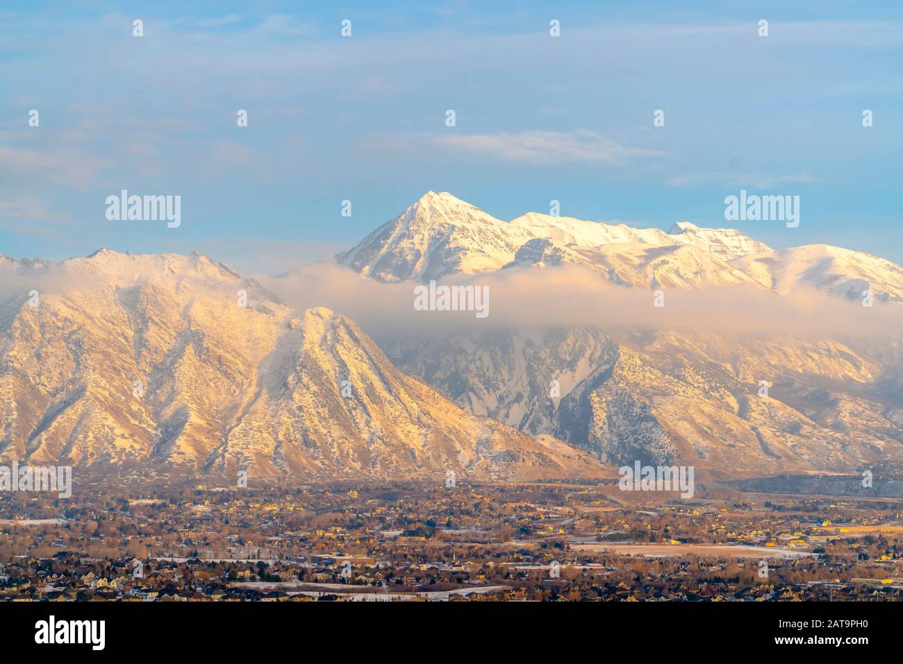 Stunning view of Mount Timpanogos with winter snow and golden glow at ...