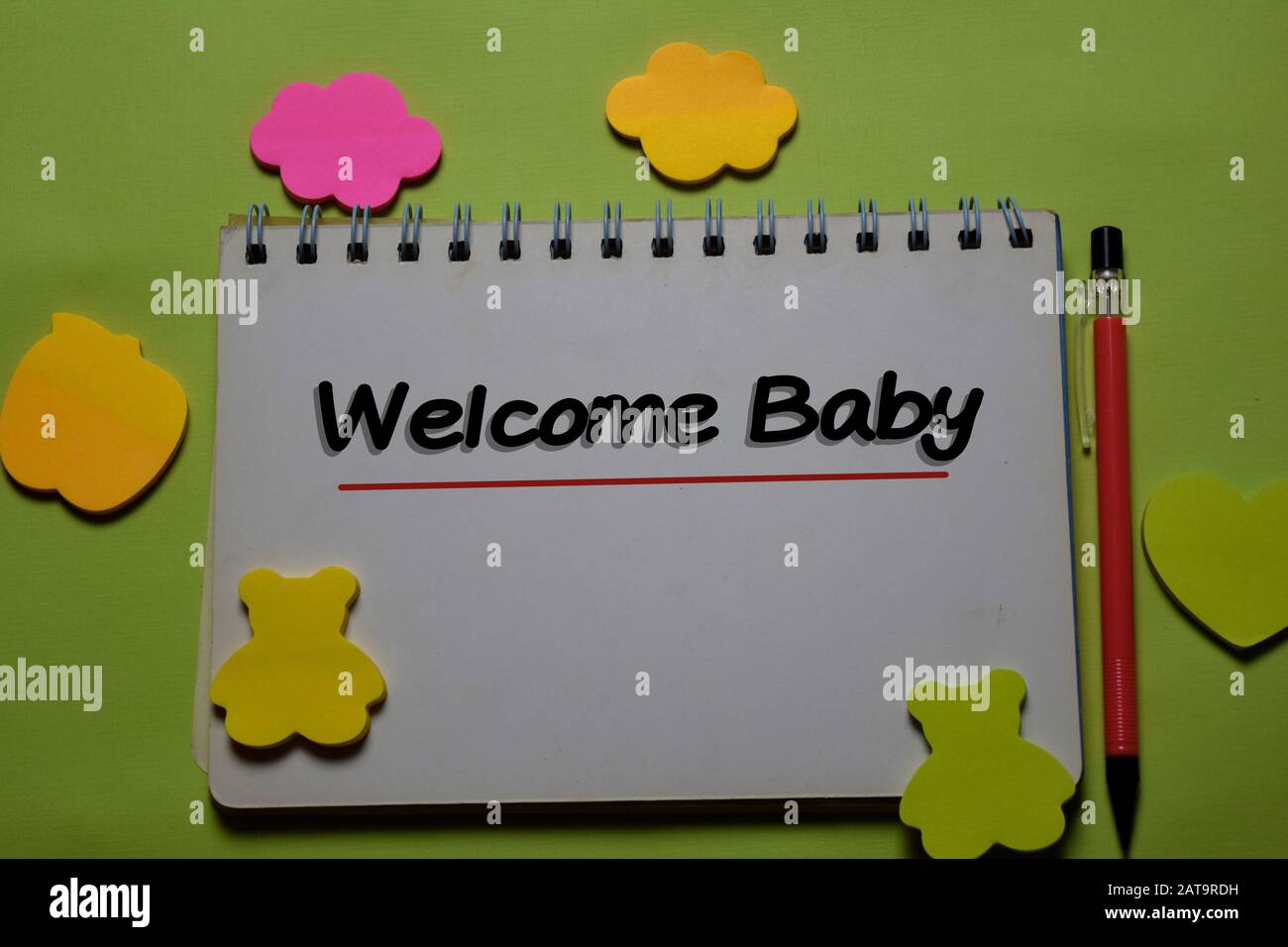 Welcome Baby write on a book isolated on office desk Stock Photo - Alamy