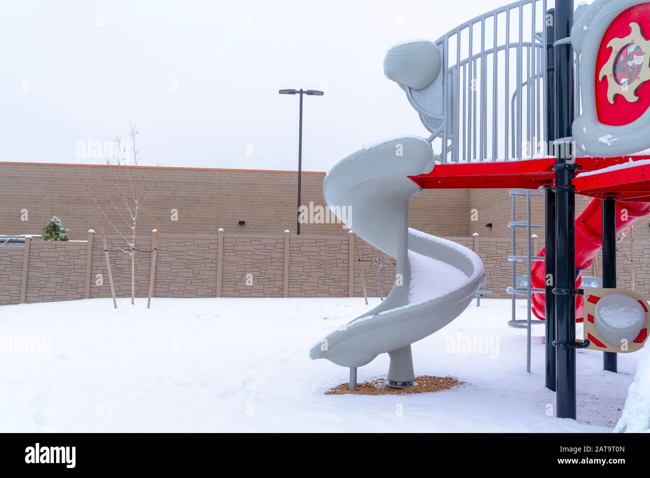Playground slides on park ground blanketed with fresh snow in winter ...