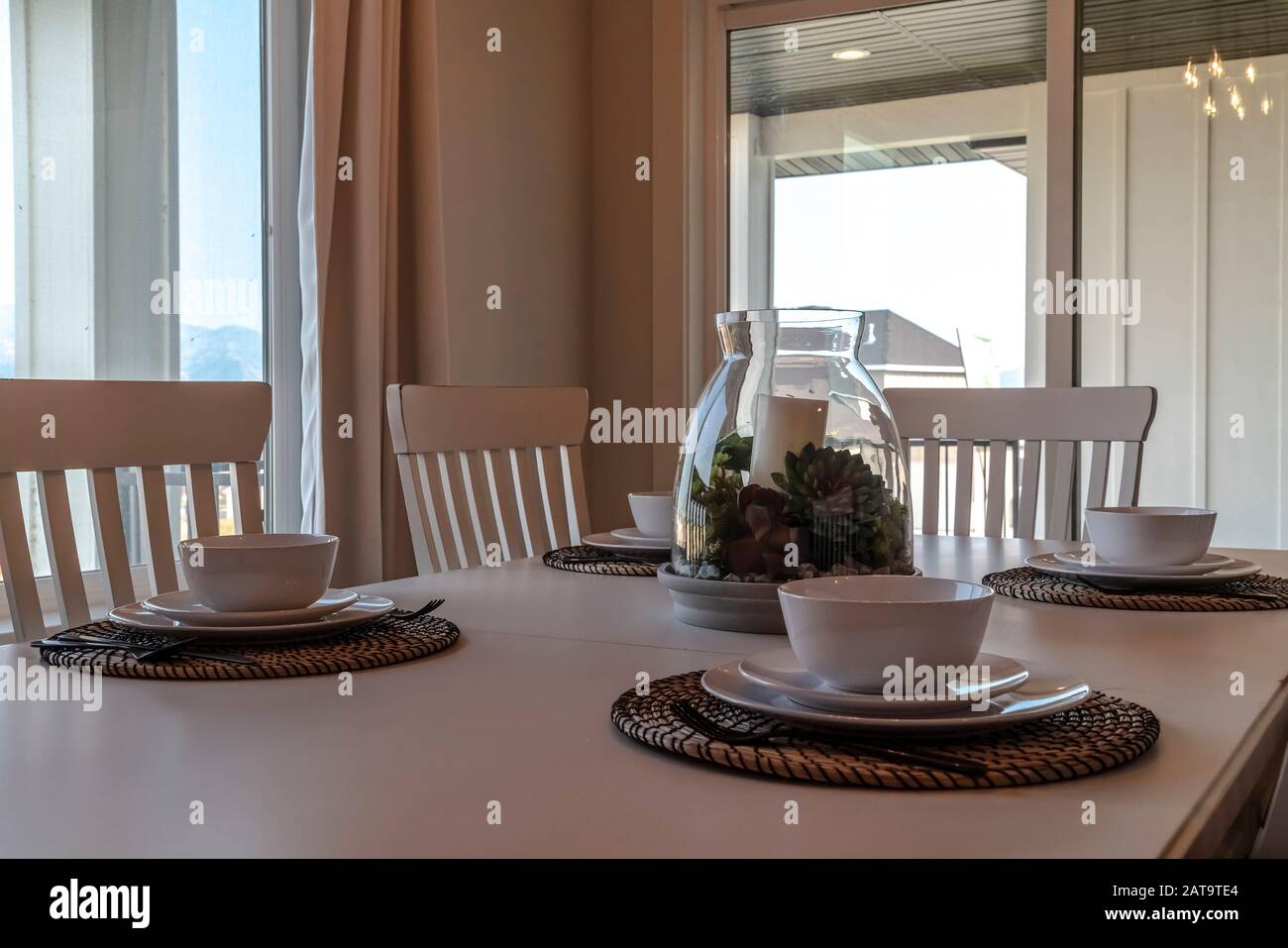 Table setting at the dining room of home against window and glass door ...
