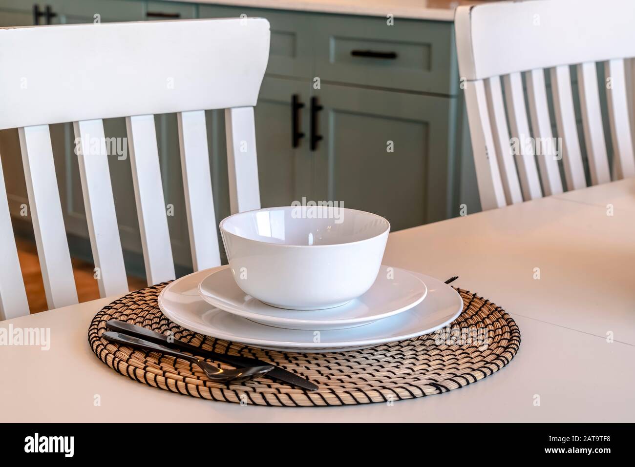 Dining table setting of home against chairs wooden floor and kitchen ...