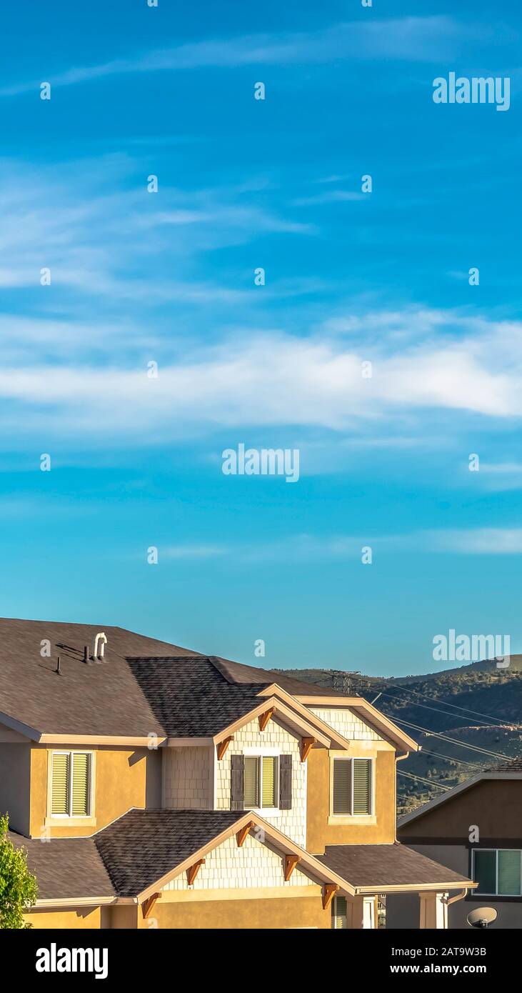 Vertical Houses with view of the roofs and upper storey against hills ...