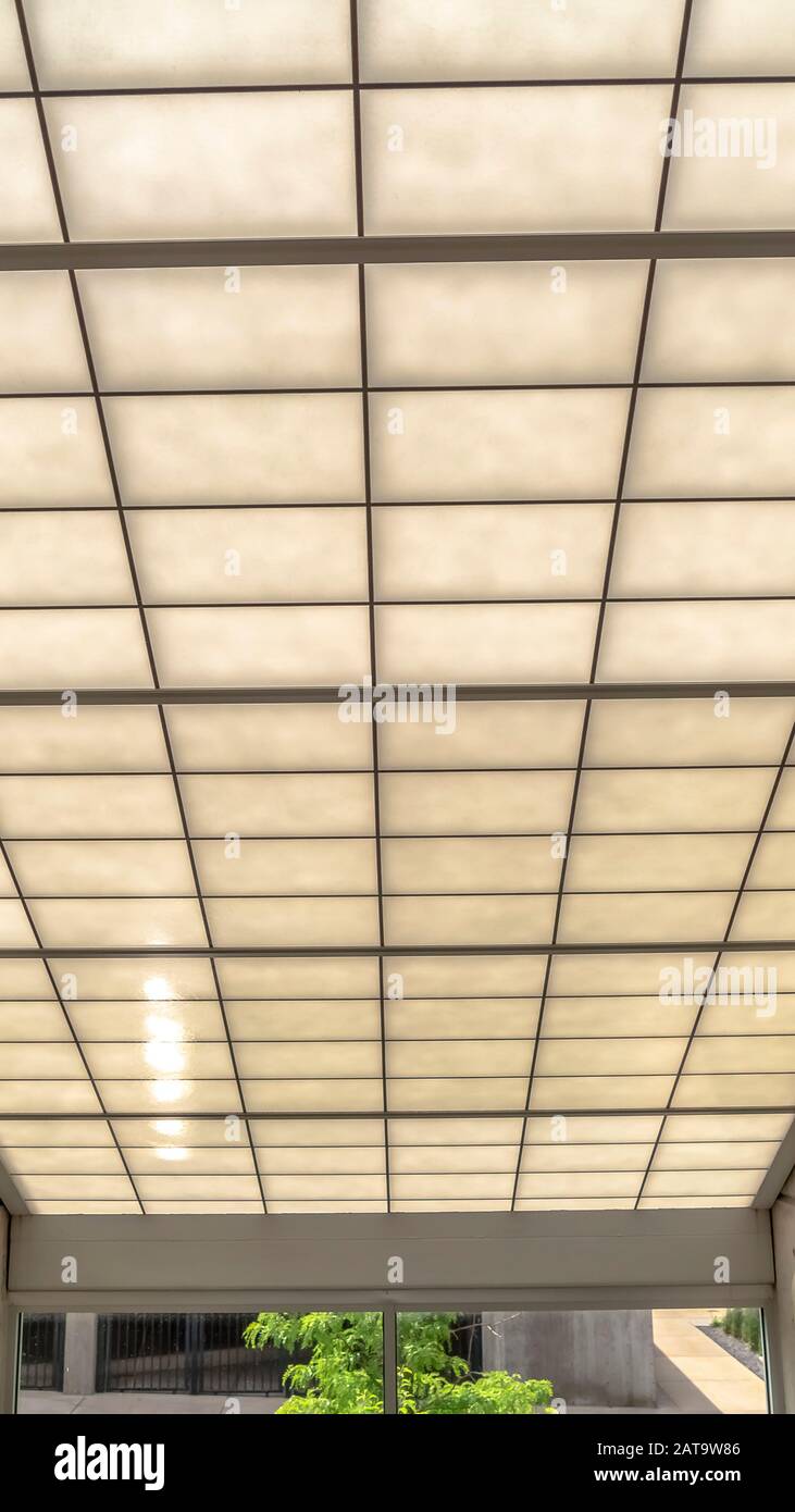 Vertical Slanted glass roof of building with concrete side wall and ...