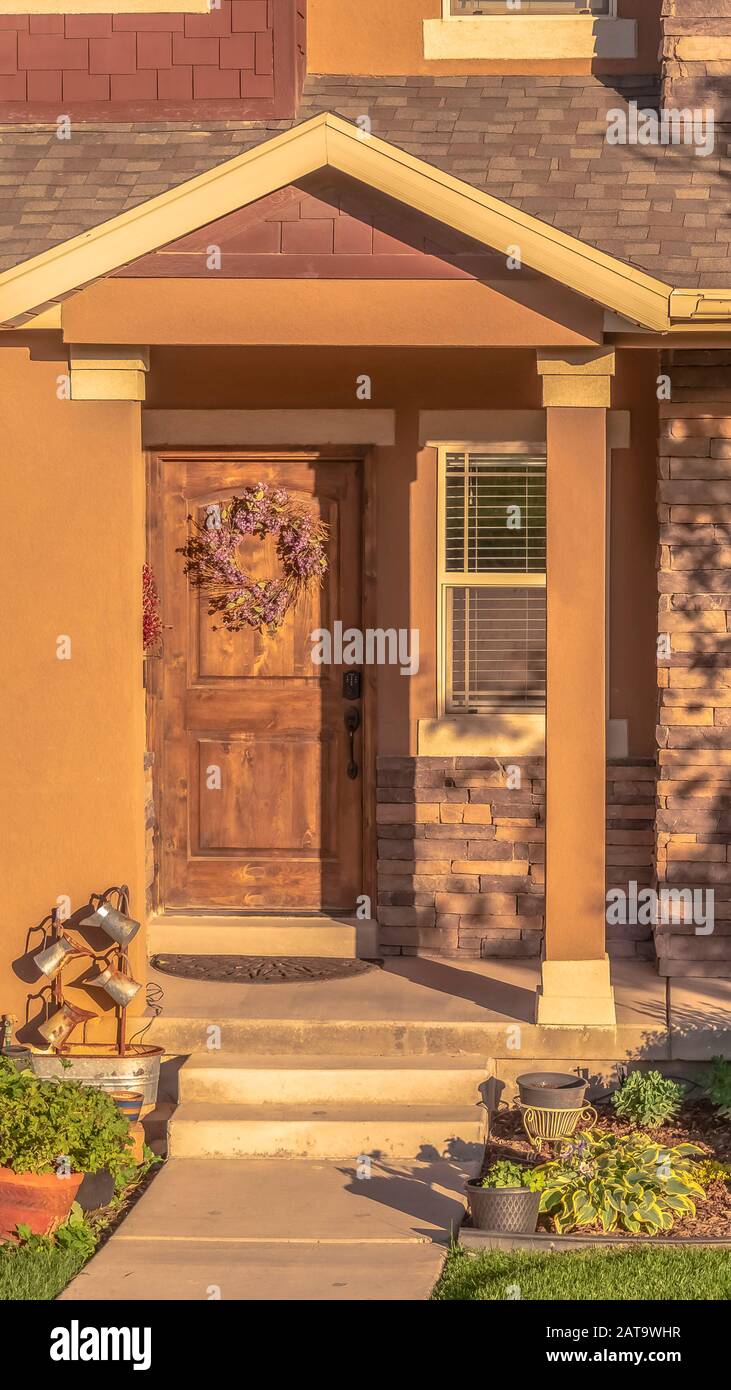 Vertical frame Home with pathway leading to gabled entrance of the ...