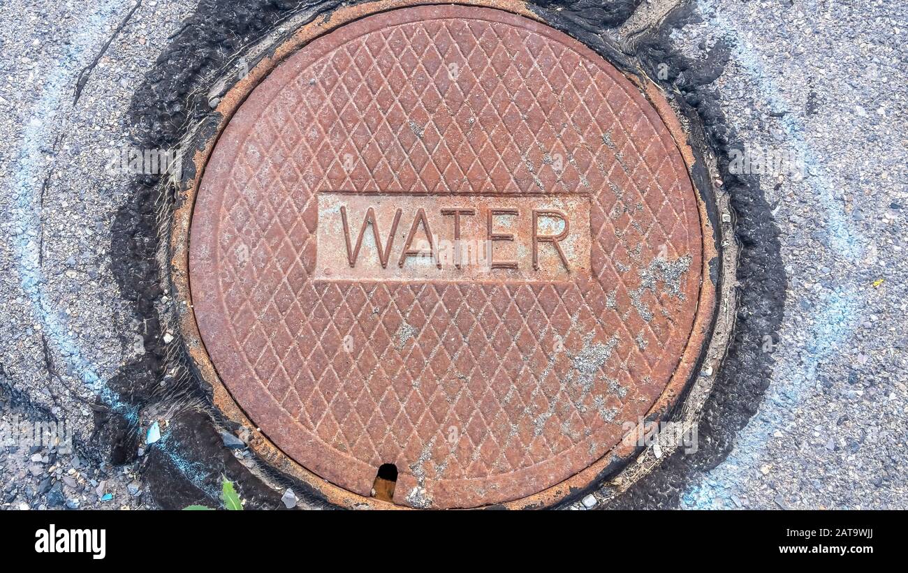 Panorama Removable circular water supply manhole cover against road and ...