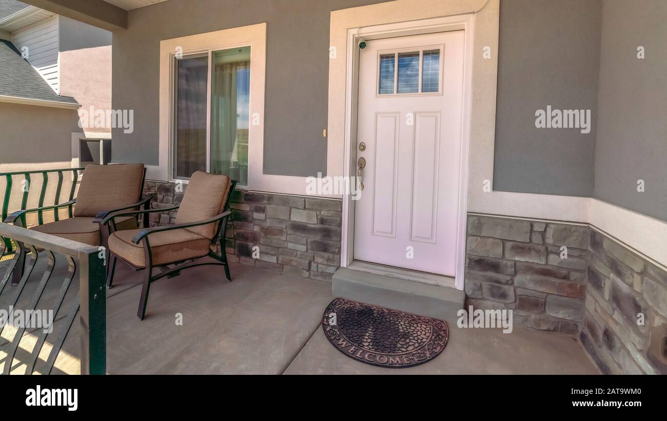 Panorama Entrance of home with chairs at the porch and front door with ...