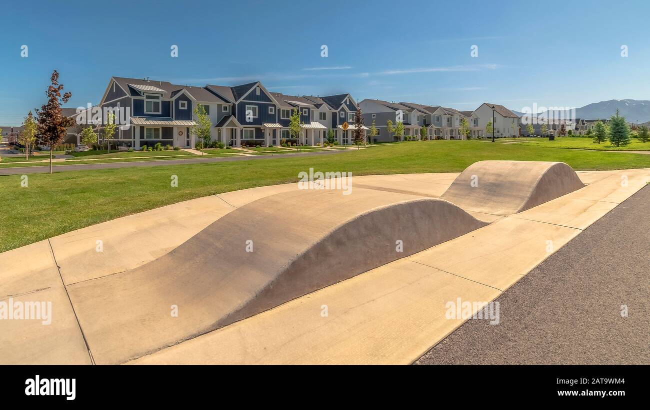 Panorama Ramp along a road and lawn in front of beautiful houses in the ...