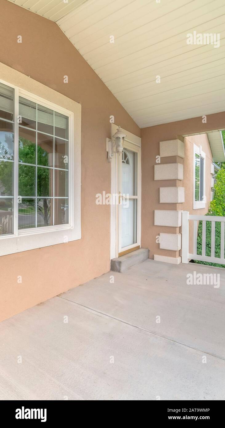 Vertical frame Home exterior with view of the large window and front ...