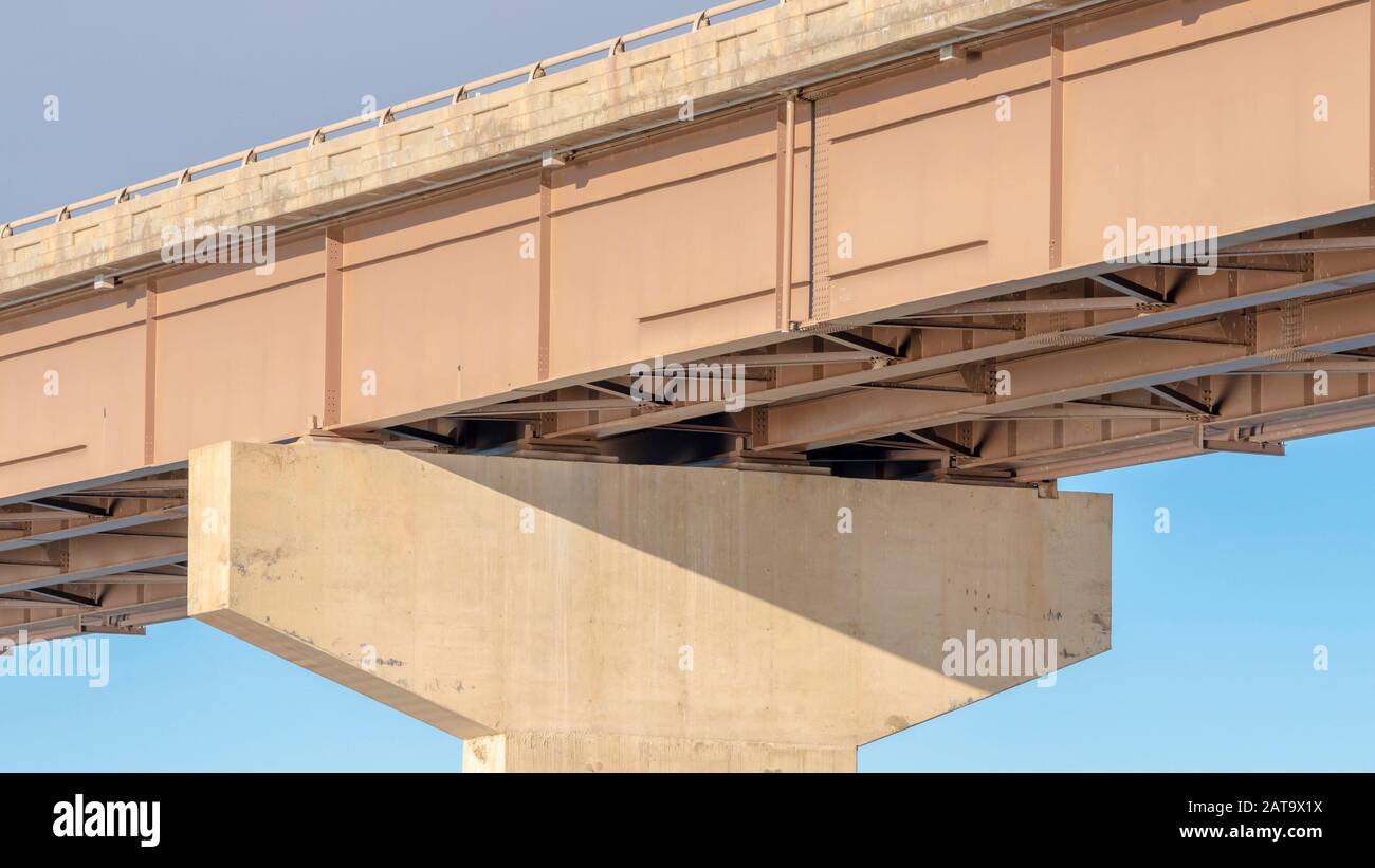 Panorama View beneath a stringer bridge with massive abutment that ...