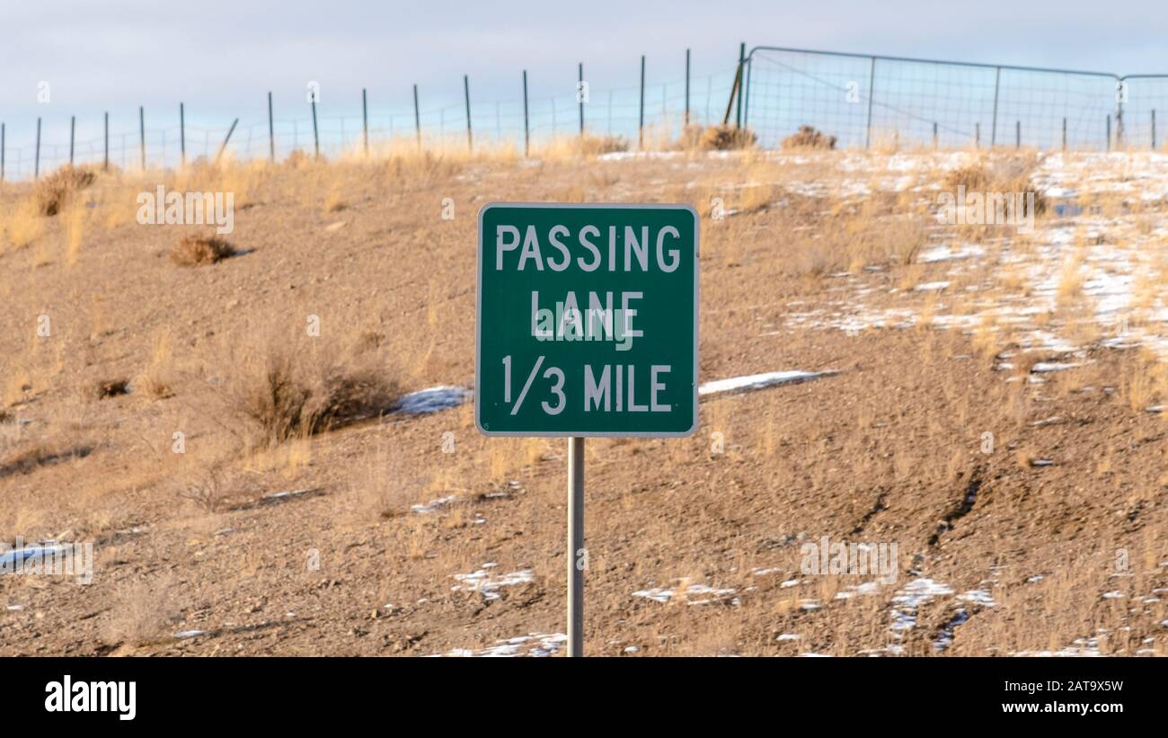 Panorama Passing Lane road sign at the side of a highway against grassy ...