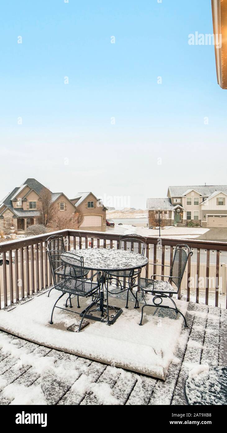 Vertical Snowy deck overlooking homes in the village blanketed with ...