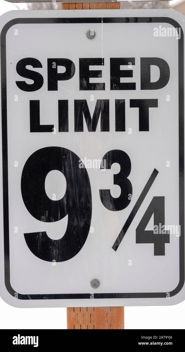 Photo Vertical frame Speed Limit sign with road and snow covered ground ...