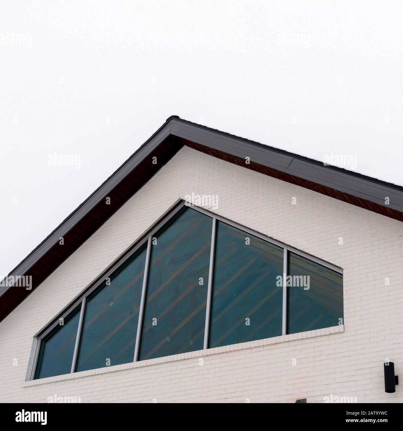 Photo Square frame Home exterior with tringular window and white wall ...