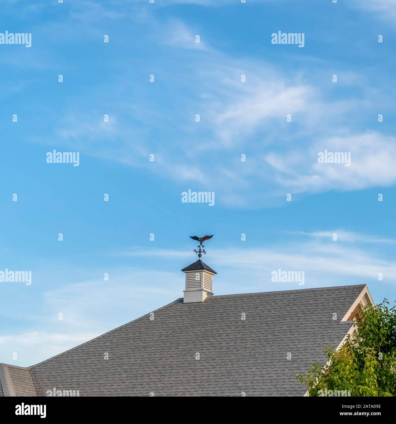Square Exterior of building with cupola and compass on the gray pitched ...