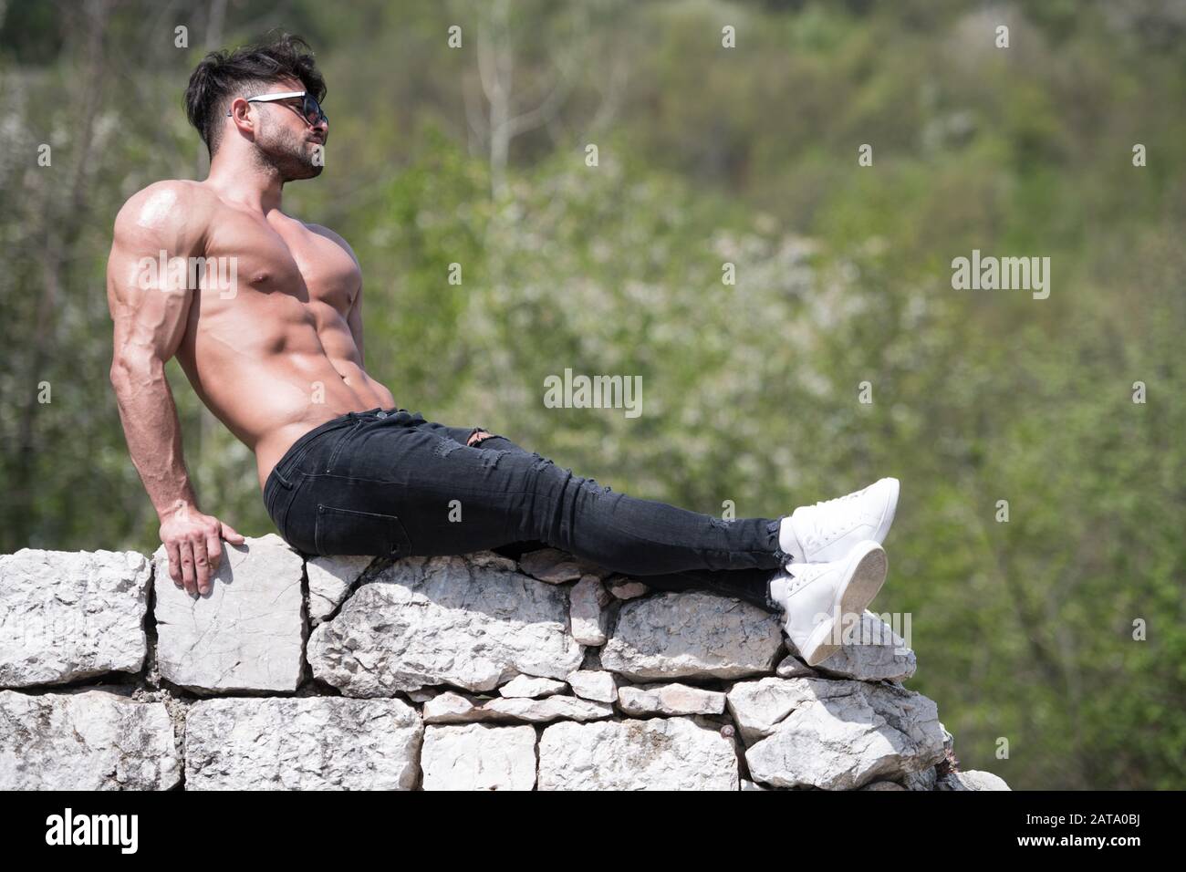 Healthy Young Man Lying Down Strong Flexing Muscles While Wearing Black ...