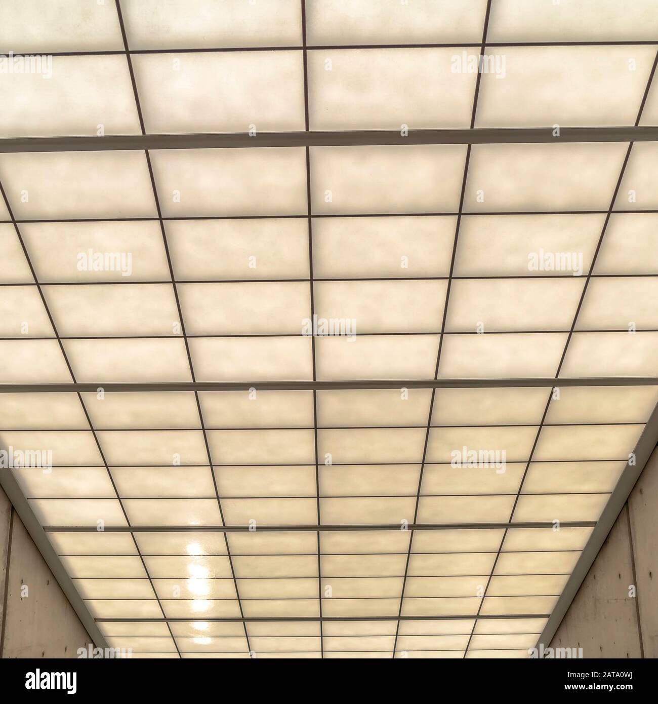 Square Slanted glass roof of building with concrete side wall and clear ...