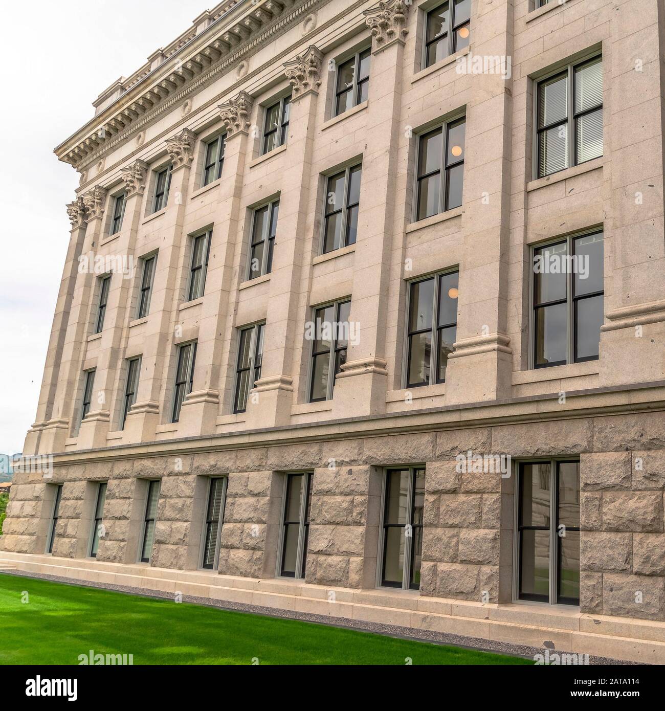 Square Building facade with decorative mouldings on the white stone ...