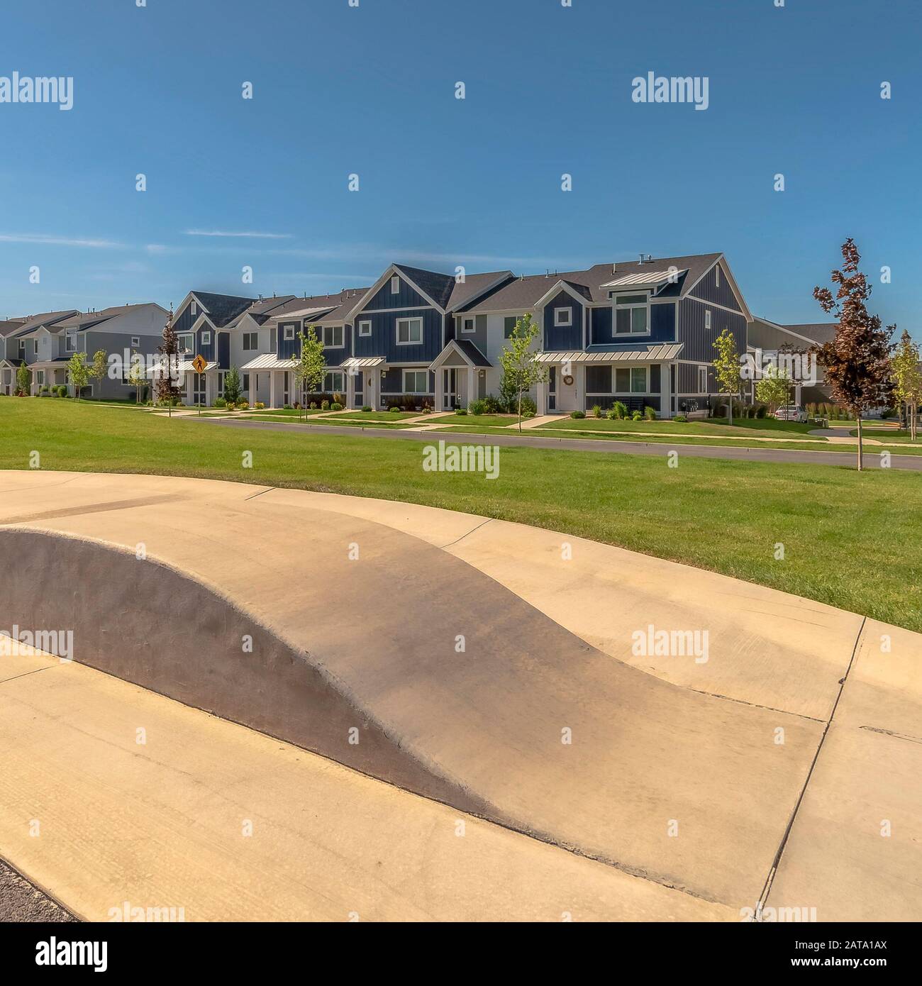 Square Ramp along a road and lawn in front of beautiful houses in the ...