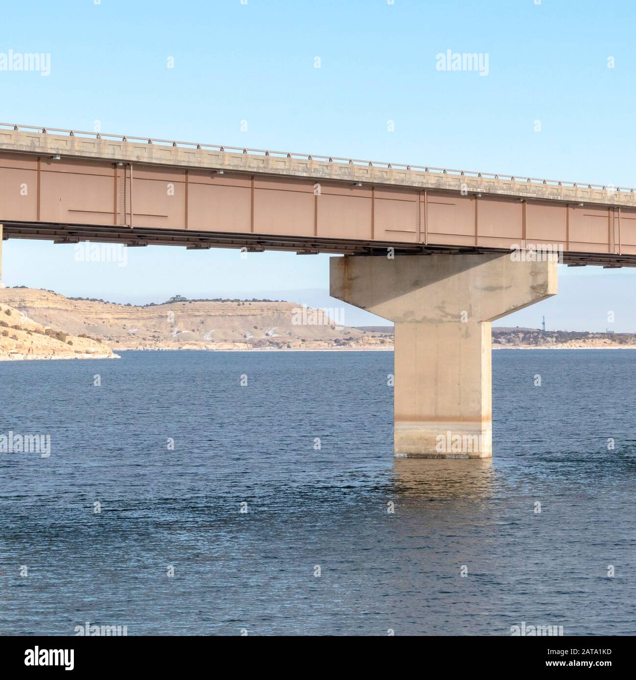 Square Stringer bridge supported by abutments ovelooking lake land and ...