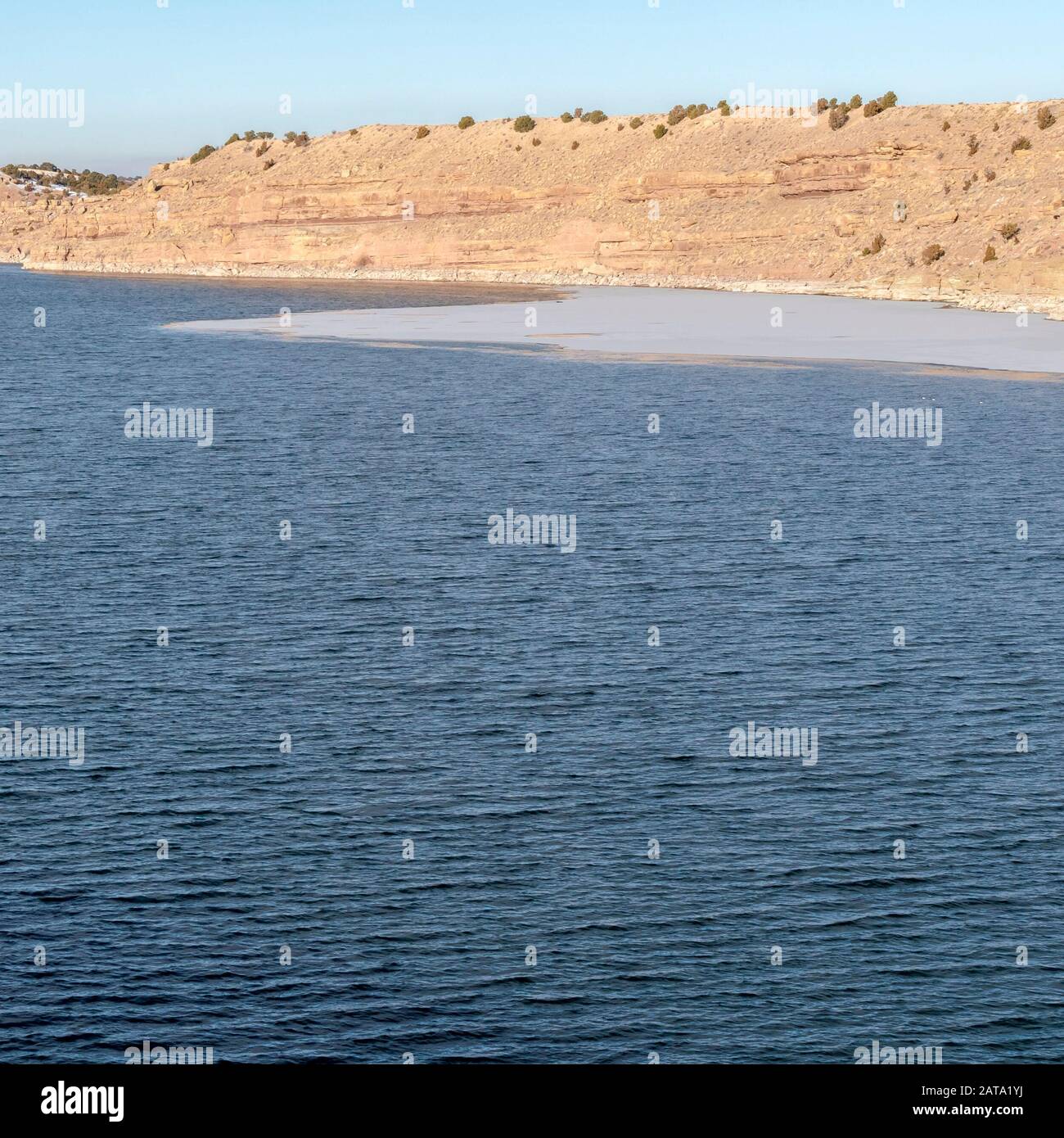 Square frame Scenic view of blue lake with frozen water near the base ...