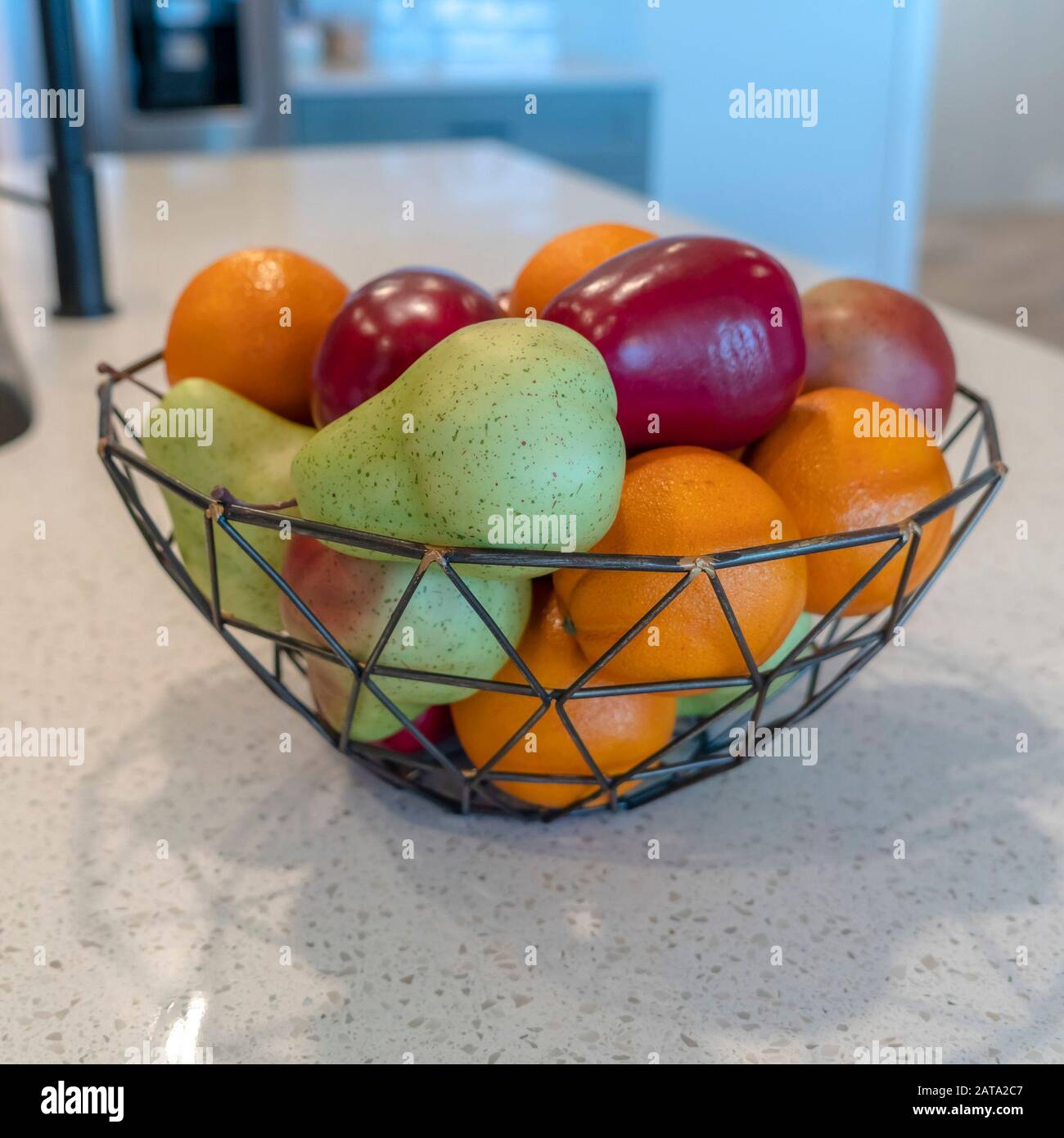 Square frame Wire geometric basket with fresh fruits against kitchen ...