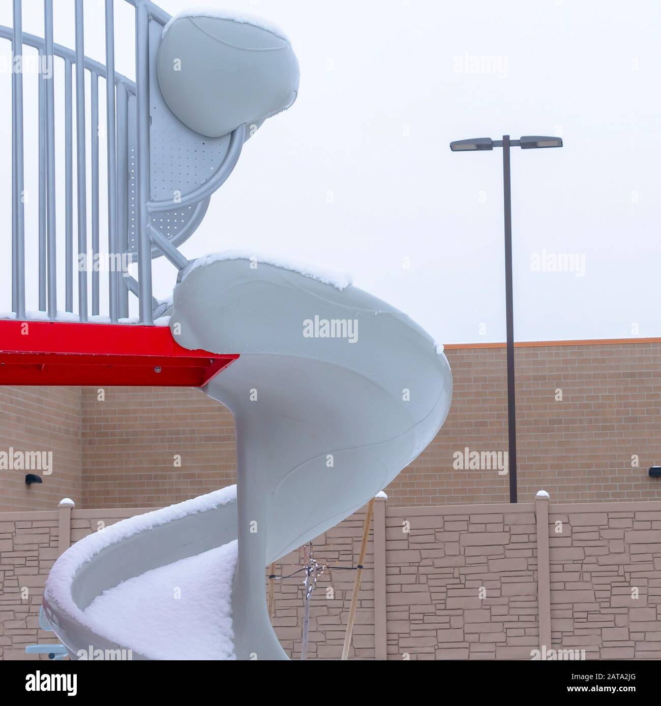 Photo Square frame Playground slides on park ground blanketed with ...