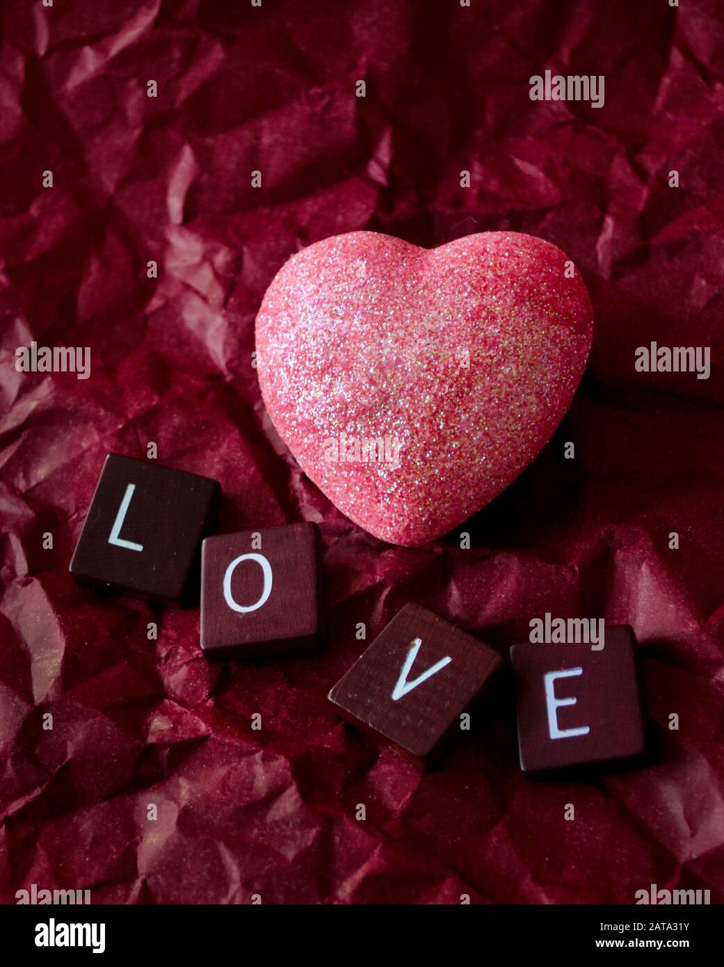tiles spell out love under a red heart on a red background Stock Photo ...