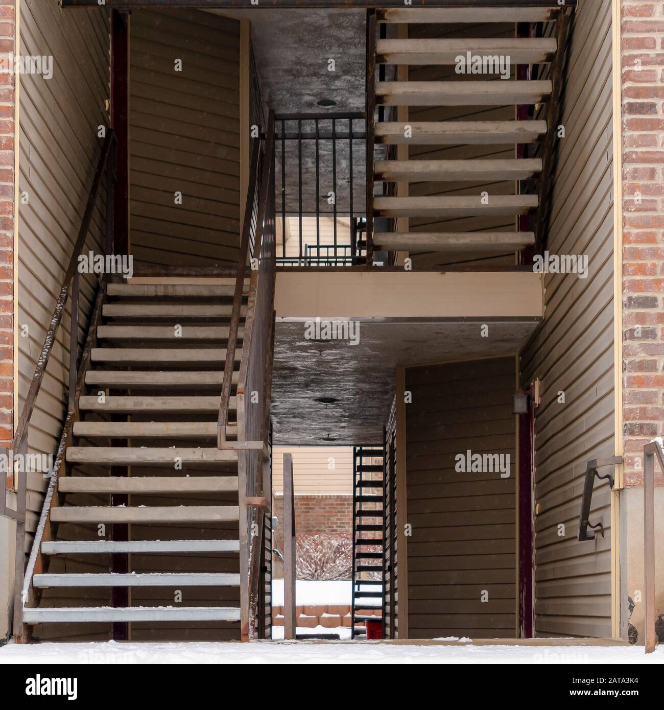 Square Residential building entrance with snow covered stairs and yard ...
