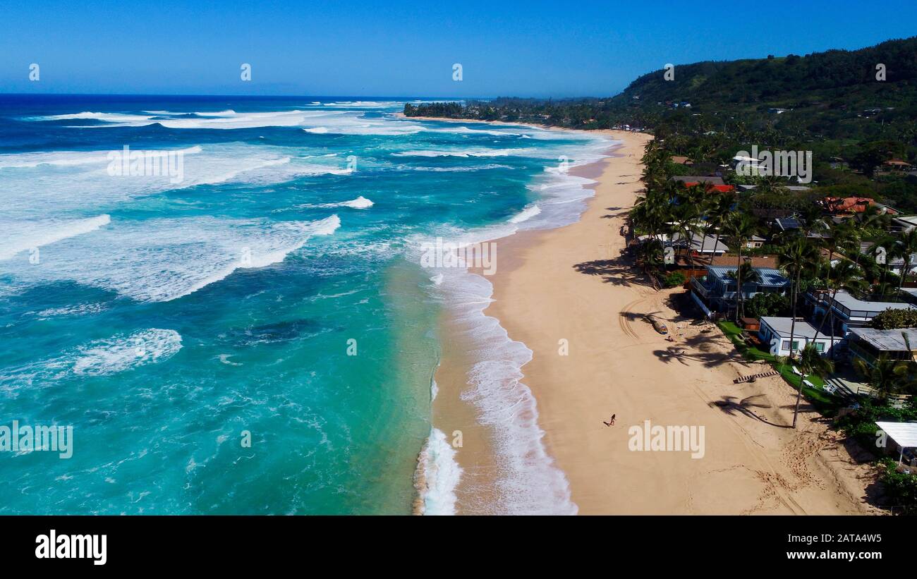 Aerial view of bright blue water and surf with waves crashing at Bonzai ...