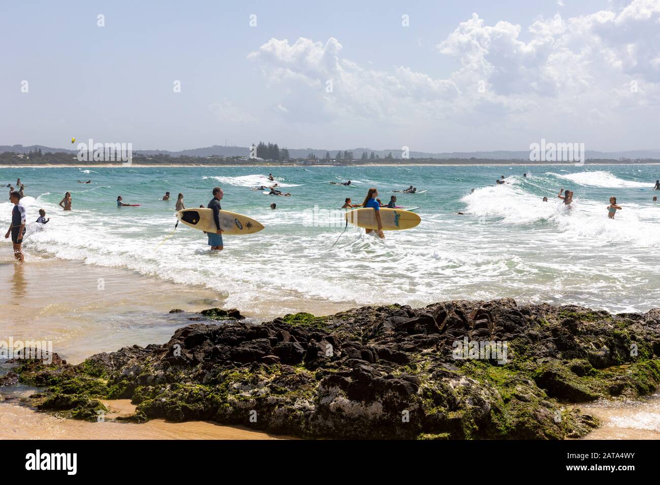 Surfers in the ocean at The Pass beach in Byron Bay, NSW, Australia ...