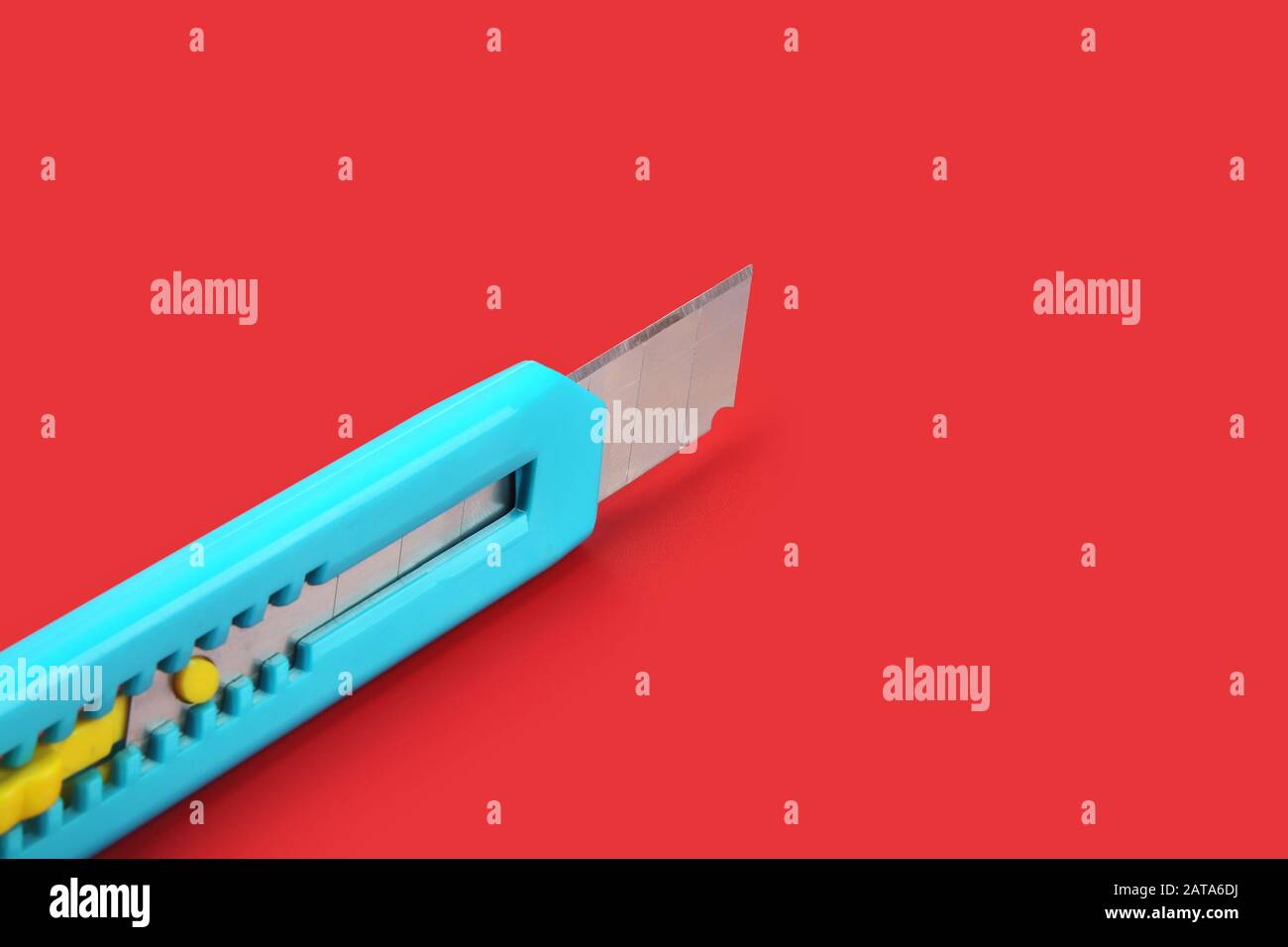 Paper cutter isolated on red background Stock Photo - Alamy