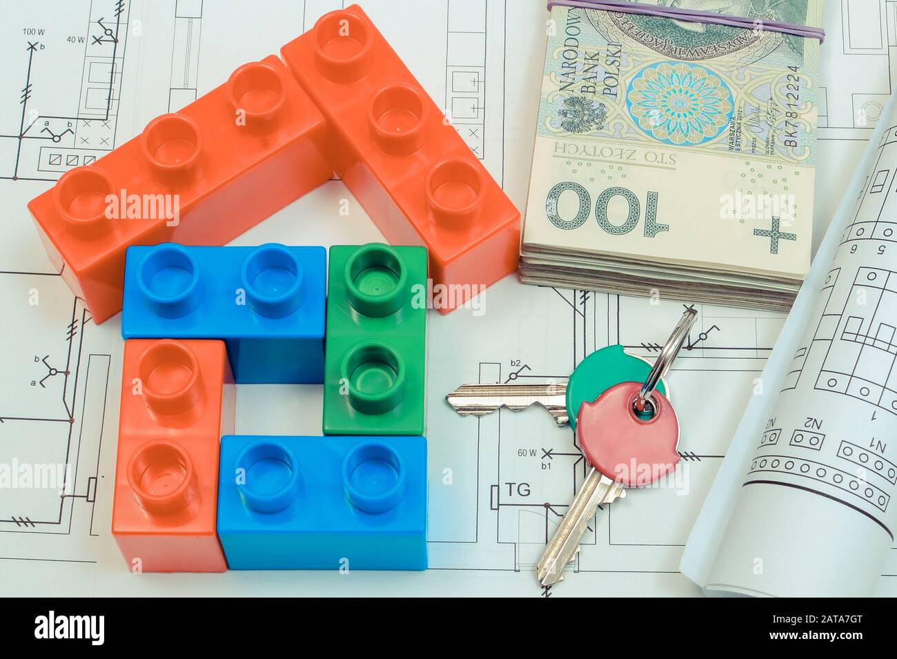 House of colorful building blocks, keys and polish currency money on ...