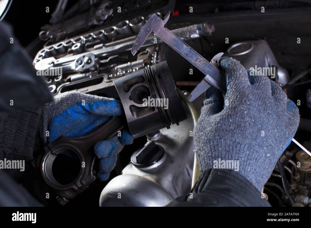 Car engine maintenance. Engine piston system repair. Hands with a ...