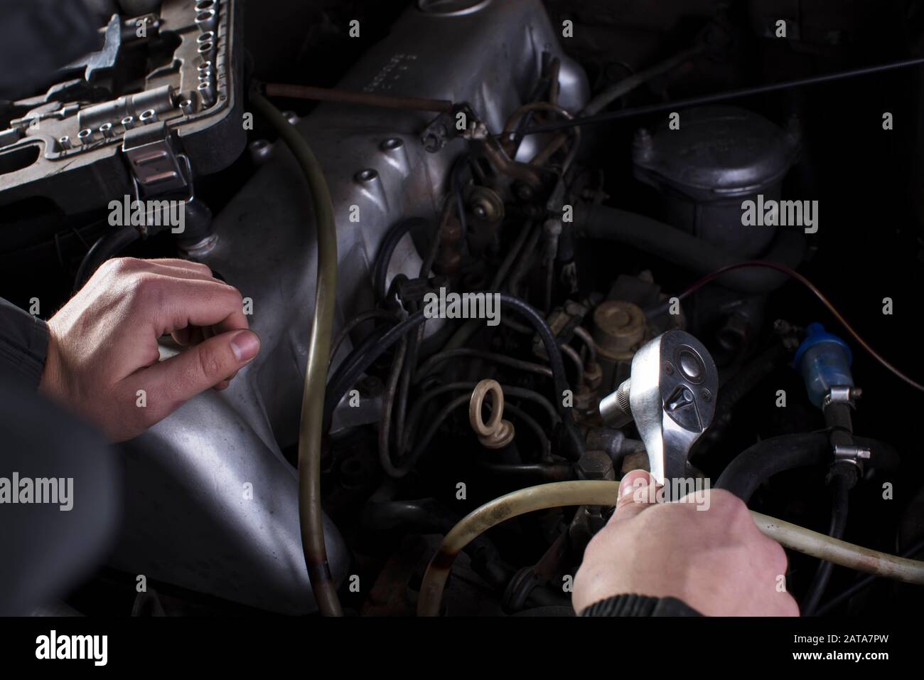Car services. Hands of a mechanic with a tool. Car engine repair Stock ...
