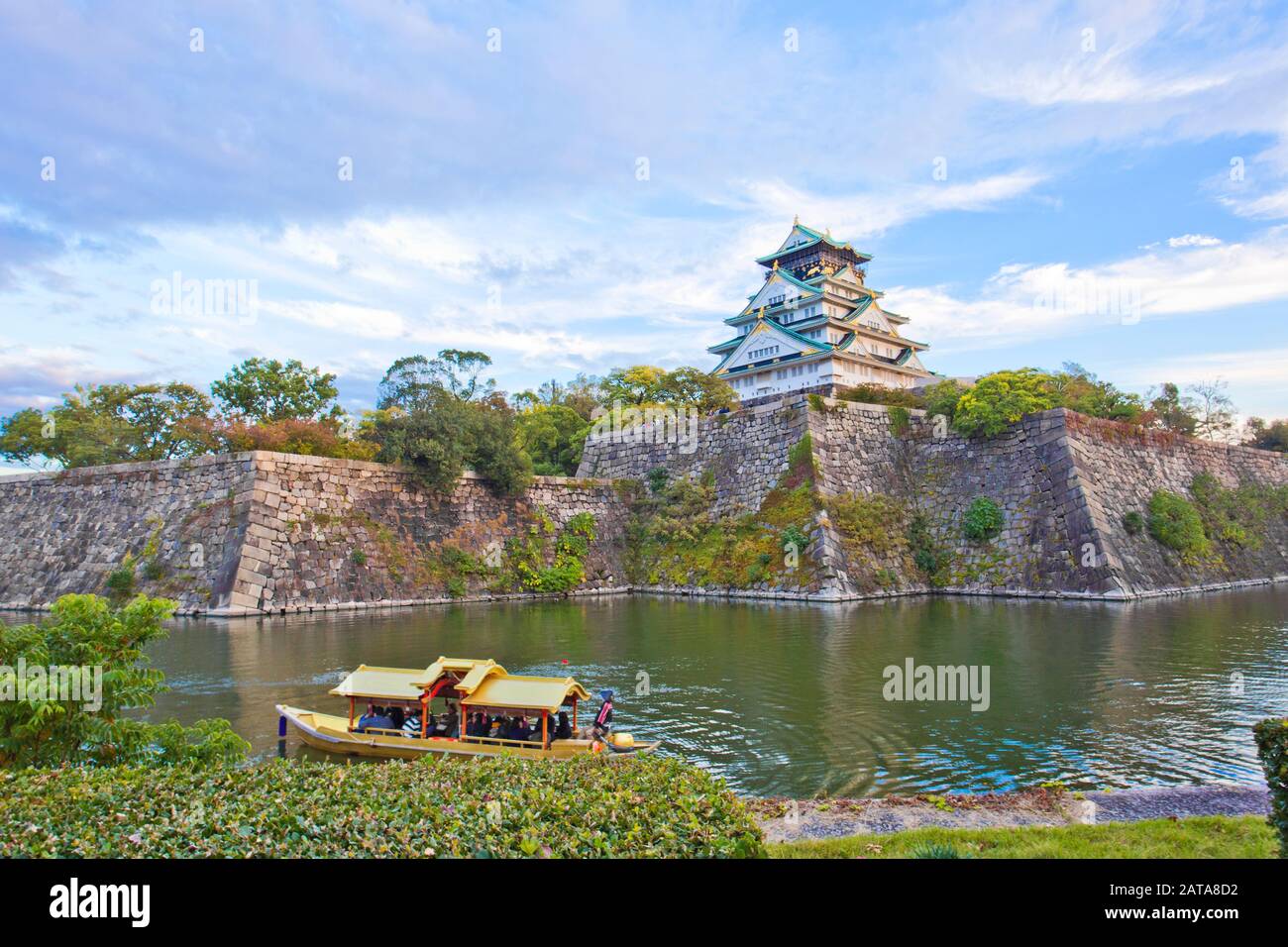 Osaka Castle walls and moat illuminated at sunset panorama Japan Stock ...