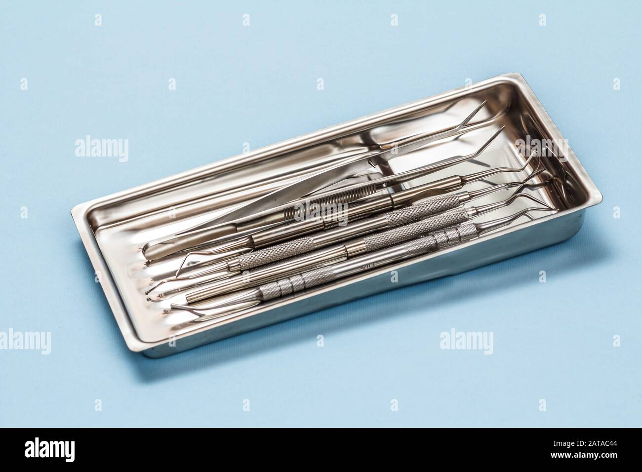 Set of metal dental instruments for dental treatment. Medical tools in ...